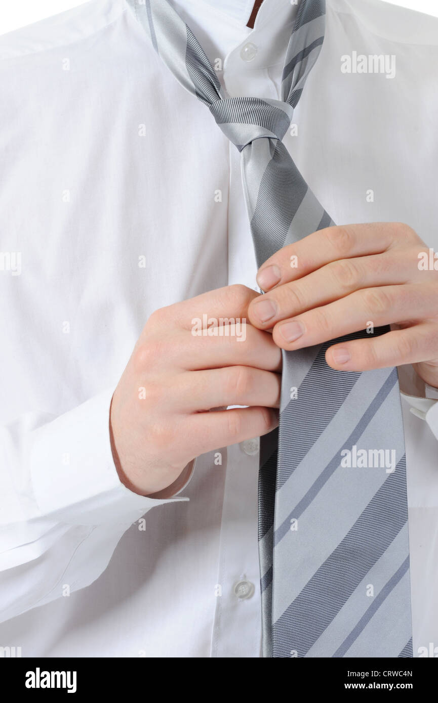 Businessman tying his tie Stock Photo - Alamy