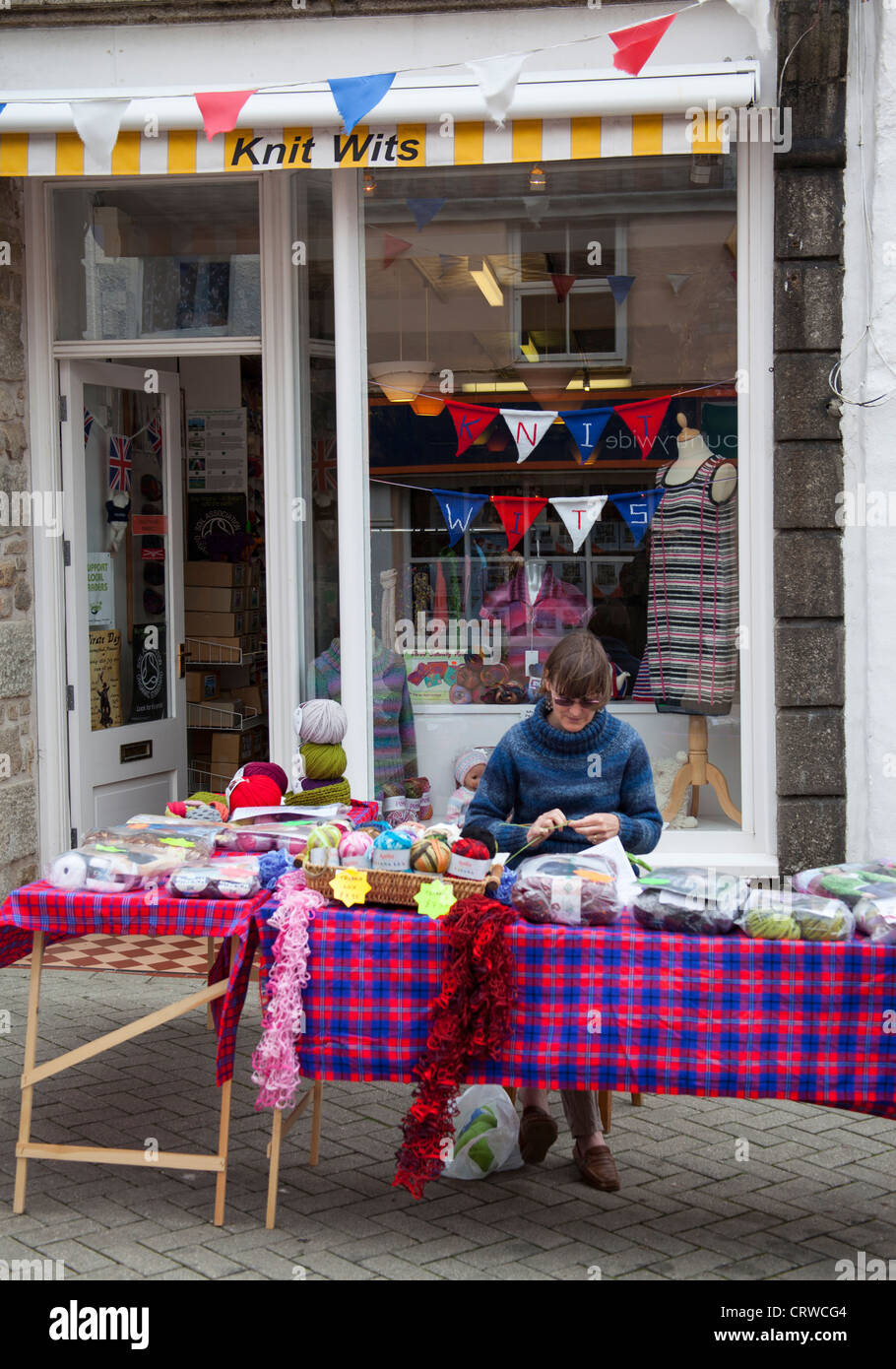 Lady knitting outside traditional style wool shop Penzance Cornwall ...