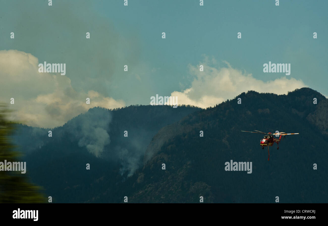 A helicopter contracted by the U.S. Forest Service drops retardant in ...
