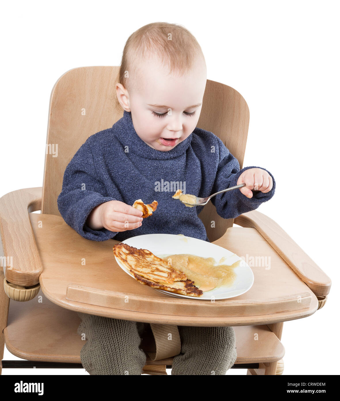 young child eating in high chair isolated in white backgound Stock ...