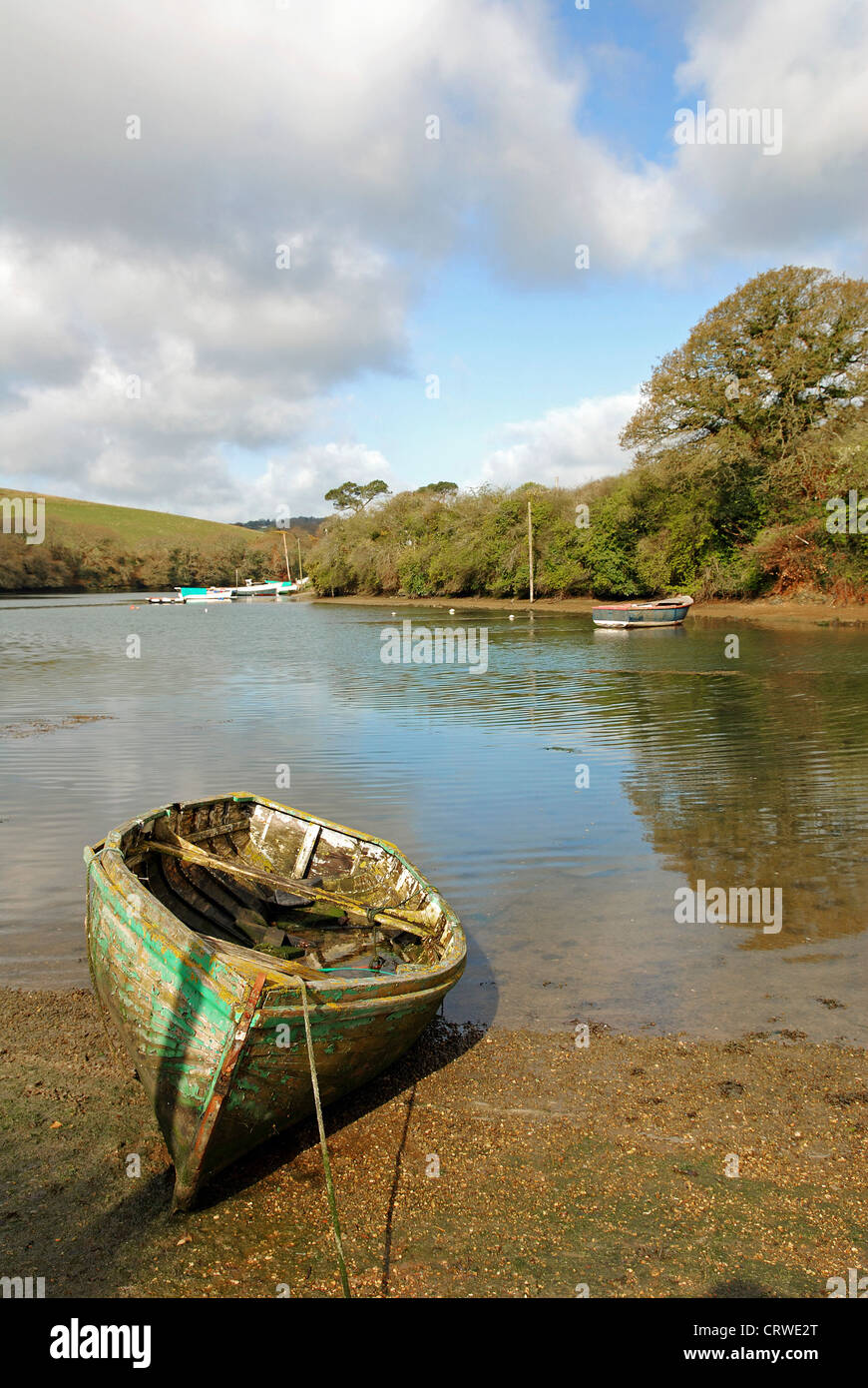 An old dinghy moored in a tidal creek off the river fal near truro in ...