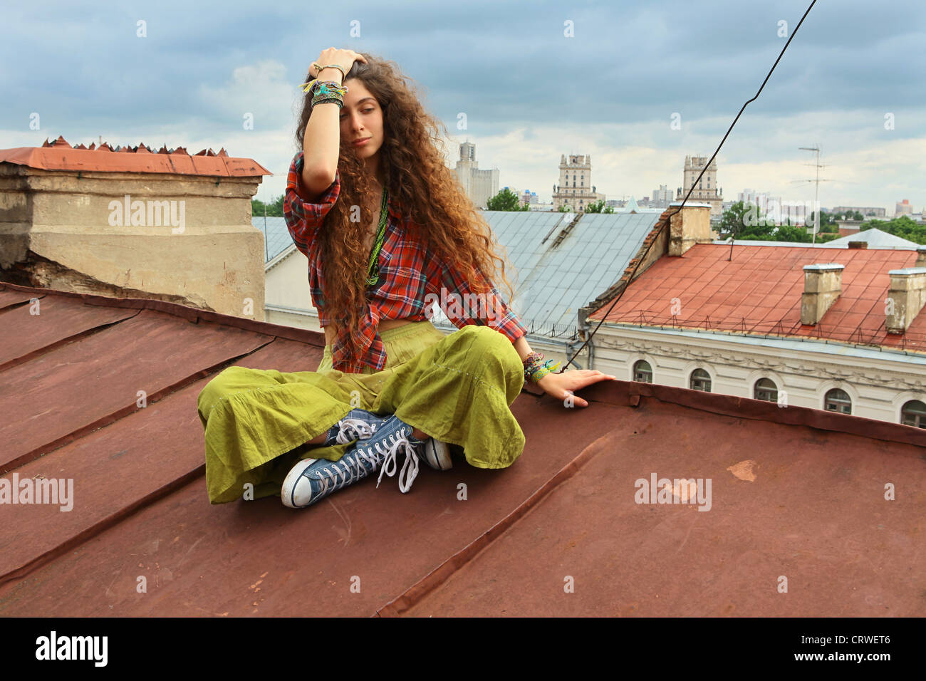 Girl on a roof Stock Photo - Alamy