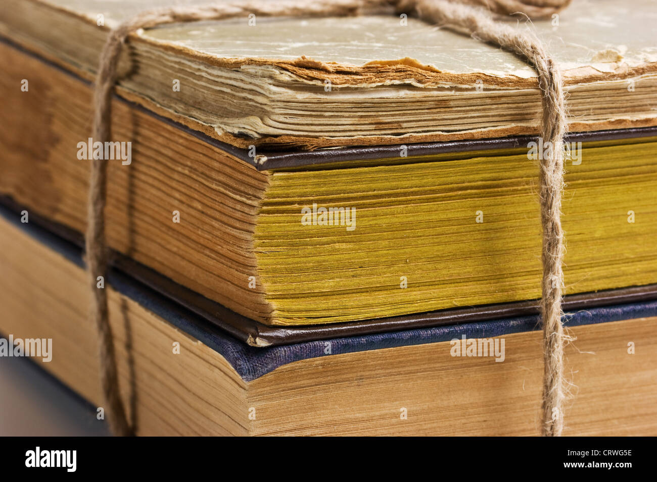 stack of old books tied with rope Stock Photo - Alamy