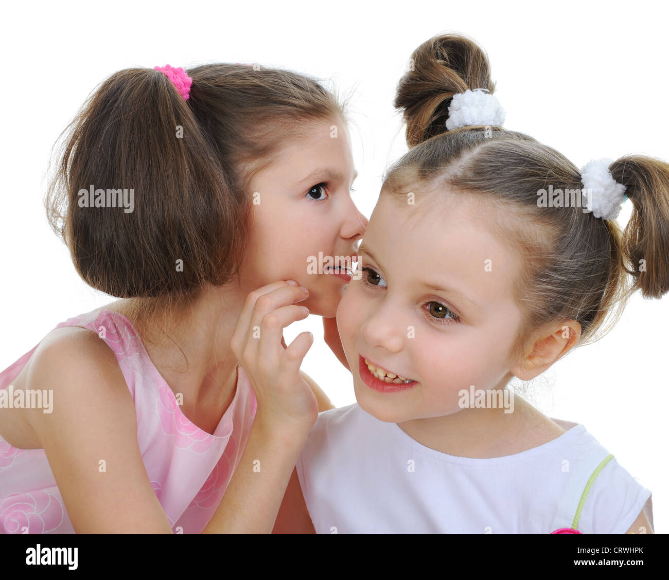 Two beautiful girls telling secret Stock Photo - Alamy