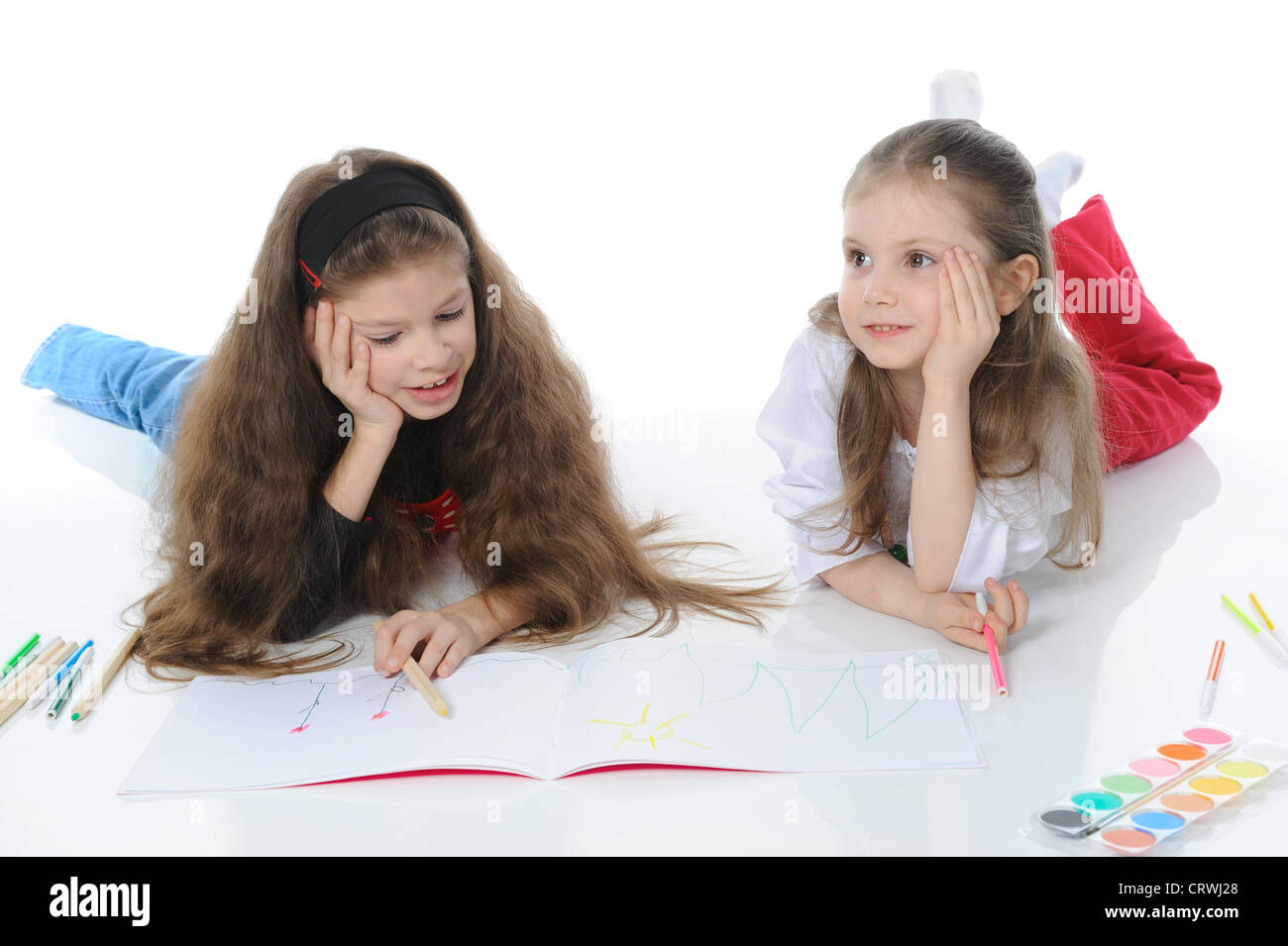 Two sisters draw on the album Stock Photo - Alamy