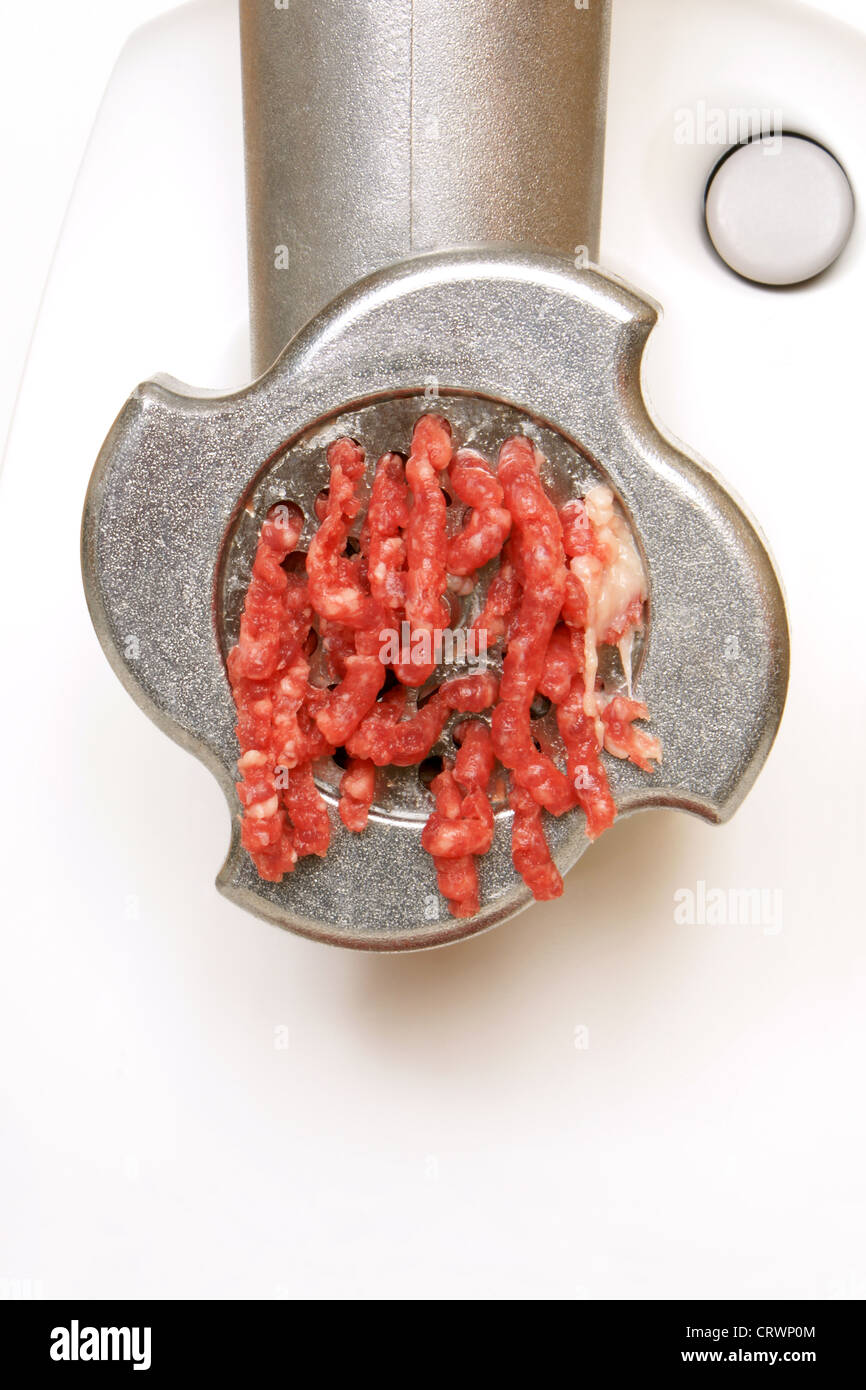 Meat grinder in action Stock Photo - Alamy