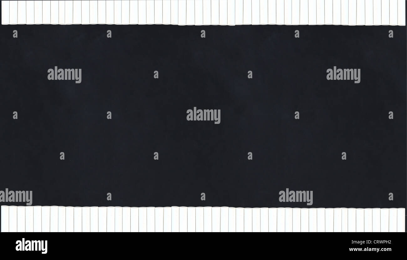 chalk sticks making a border along a black chalkboard - horizontal ...