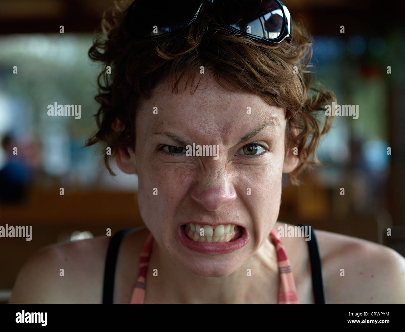 A young girl's face with angry grimace Stock Photo - Alamy