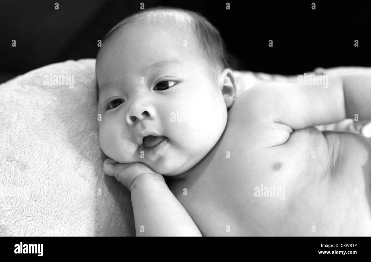 baby lying on side smiling Stock Photo - Alamy