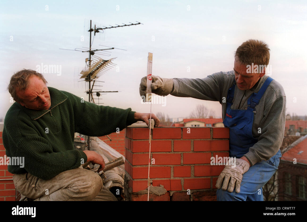 Two chimney builder at work Stock Photo - Alamy