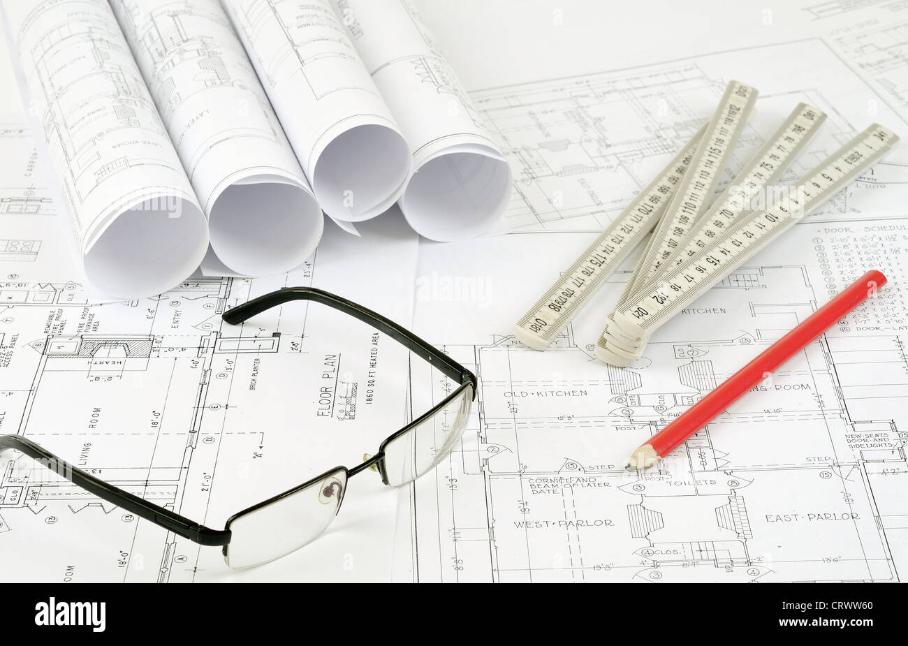 roled up plans on the table with glasses measure and pencil Stock Photo ...