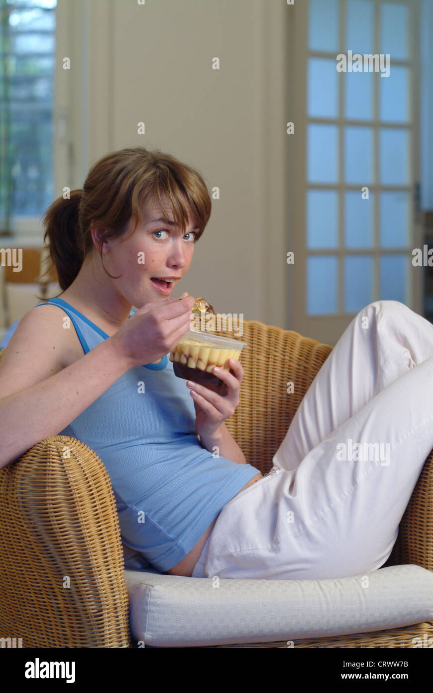 Young woman eating a pudding Stock Photo - Alamy
