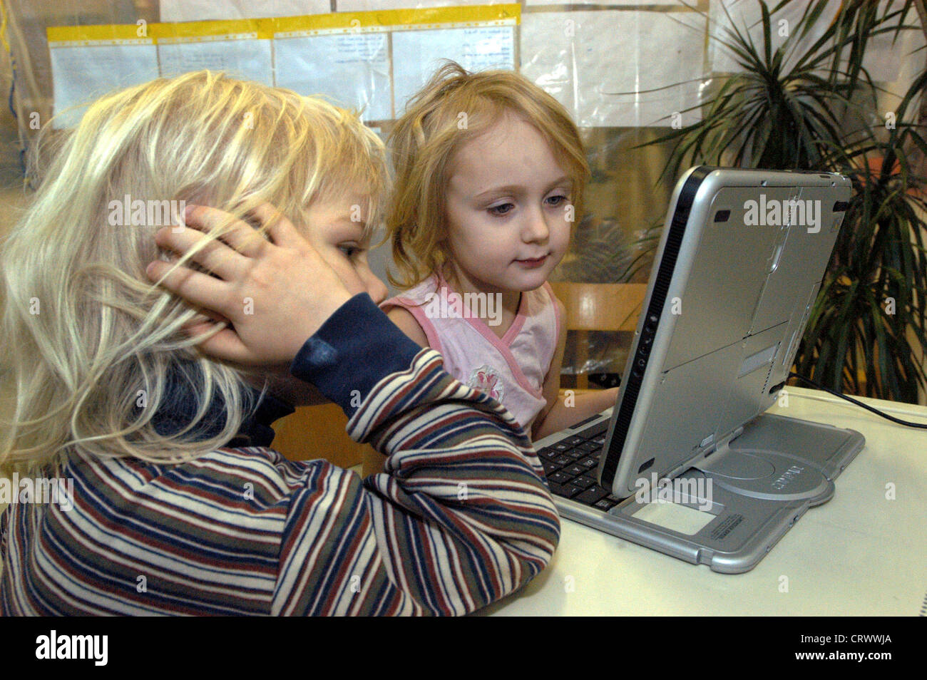 Two girls learn the computer Stock Photo - Alamy