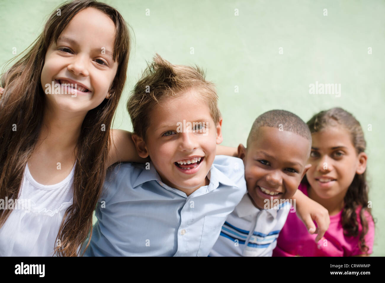 Group of happy children smiling, embracing and looking at camera. Copy ...