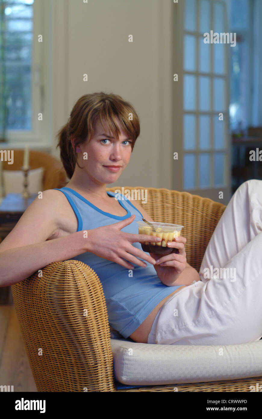 Young woman eating a pudding Stock Photo - Alamy