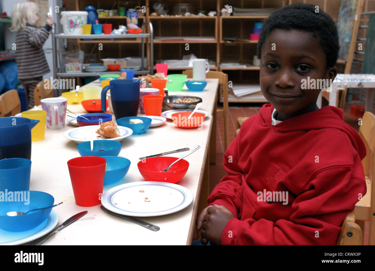 A boy at breakfast in kindergarten Stock Photo - Alamy