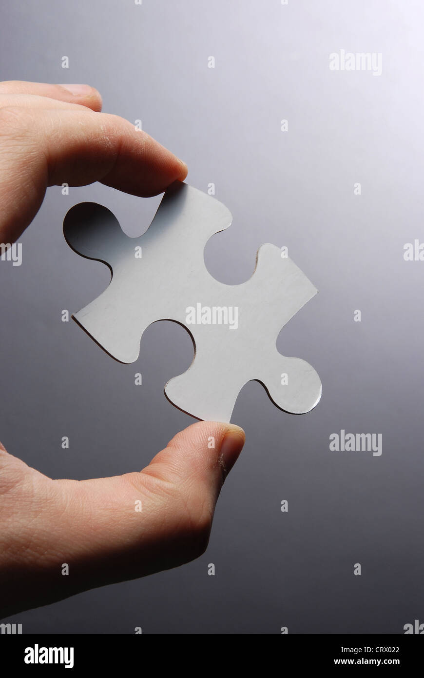Hand holding a puzzle piece high resolution image Stock Photo - Alamy