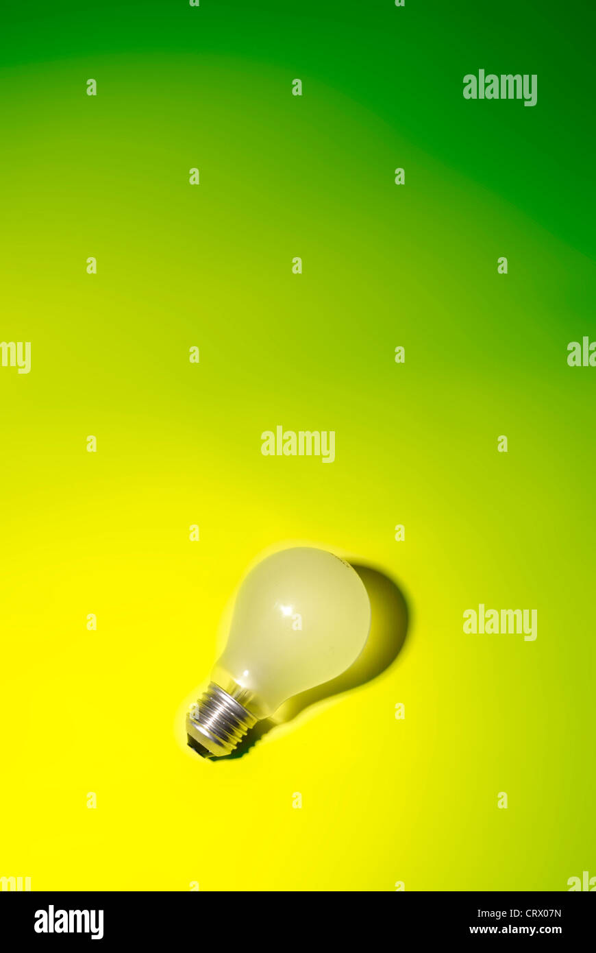 Light bulb on green background Stock Photo - Alamy