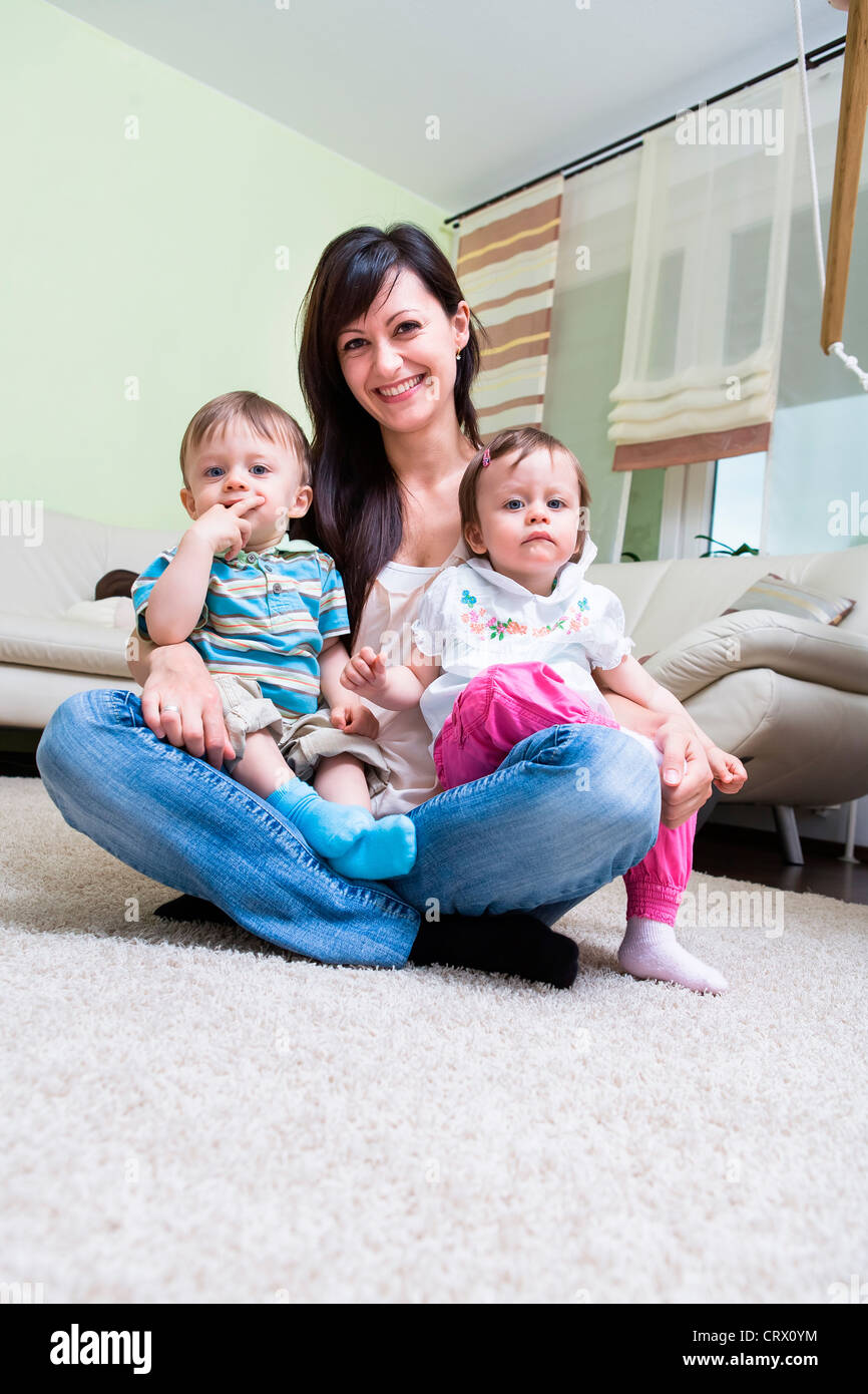 a young mother with twins in the flat Stock Photo - Alamy