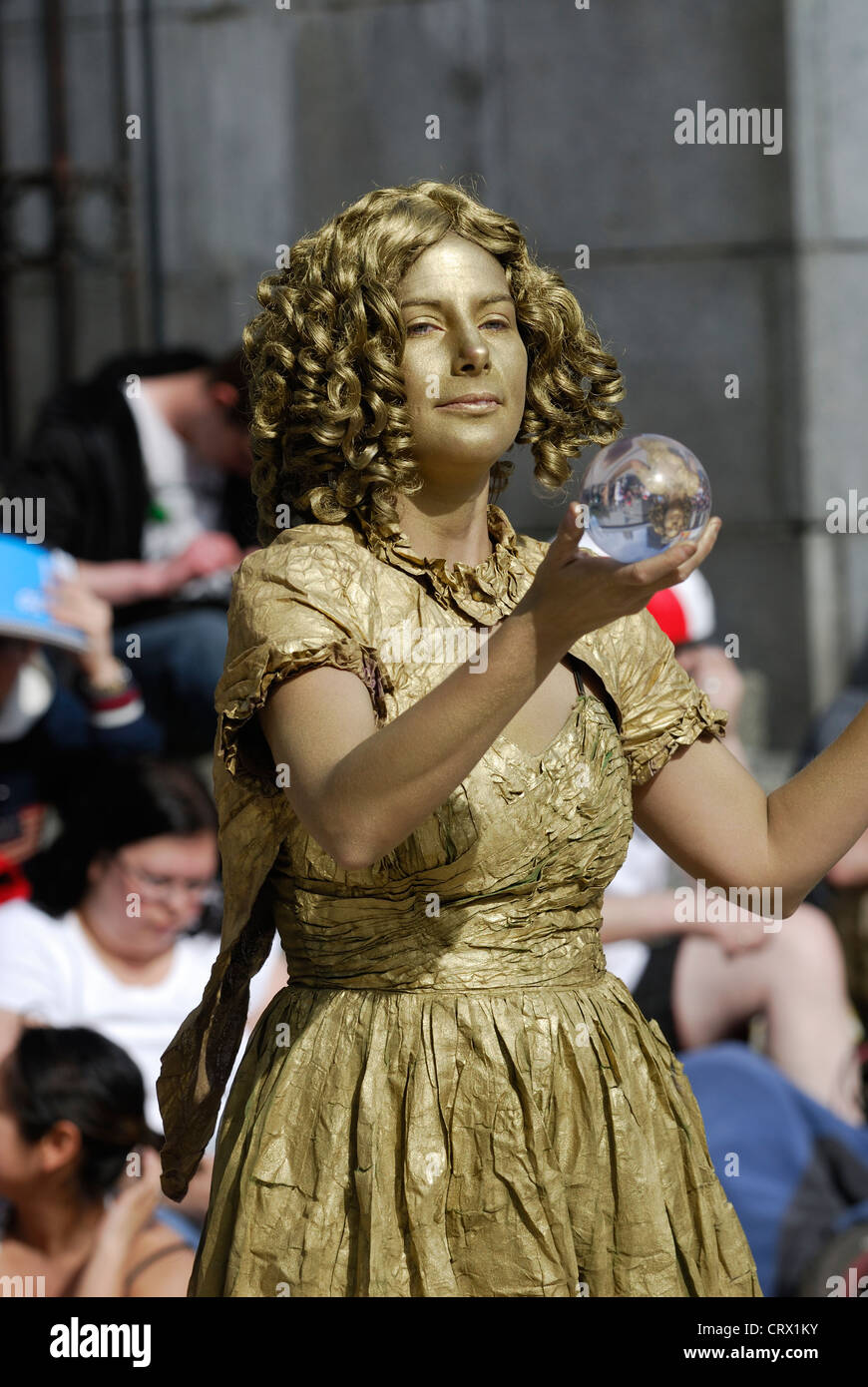Female street performer painted in gold Stock Photo - Alamy