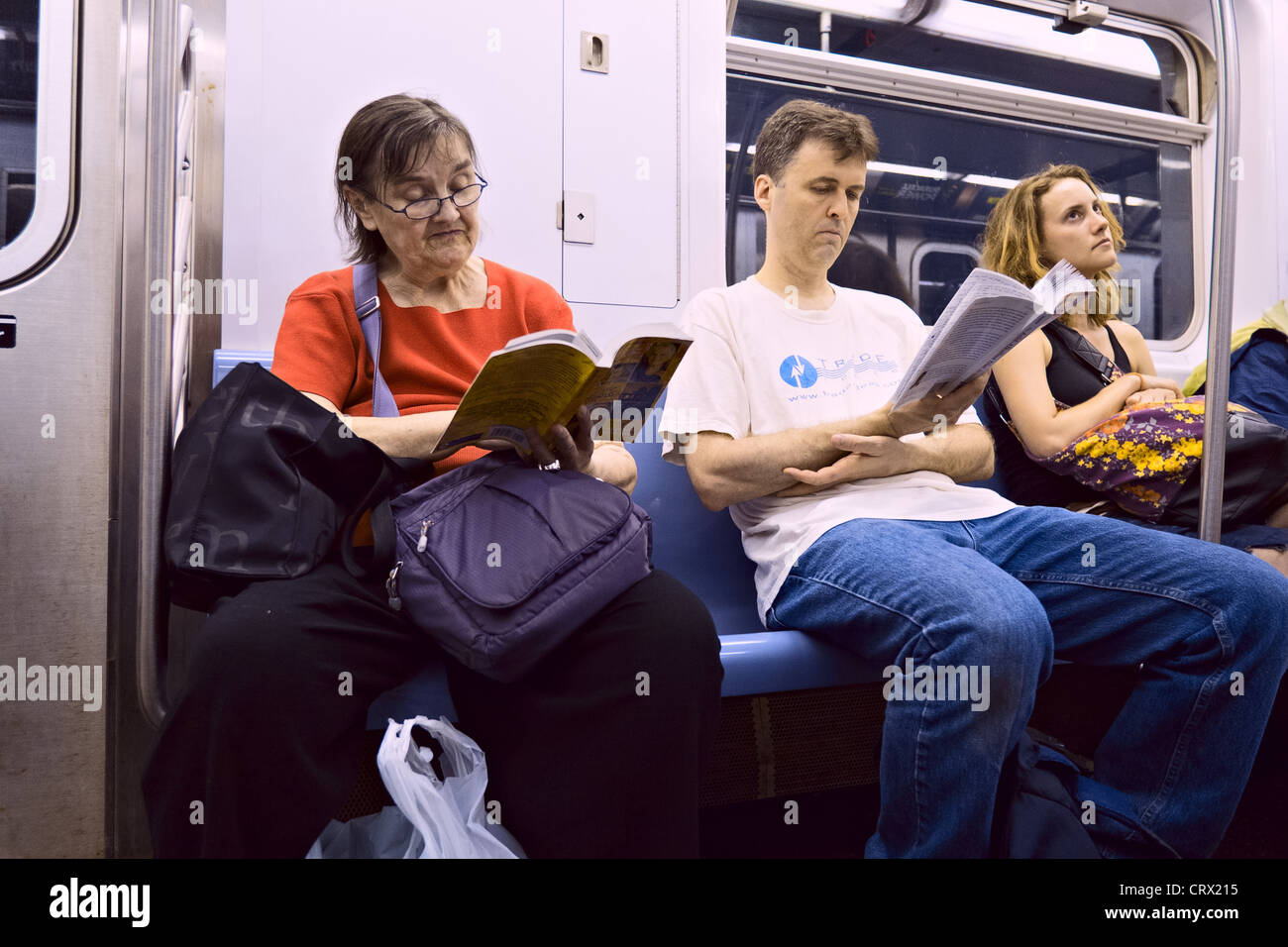 People reading books on subway Stock Photo - Alamy