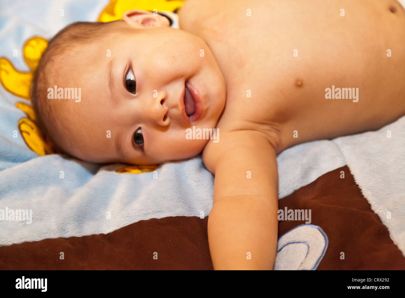 baby boy on back looking to side Stock Photo - Alamy