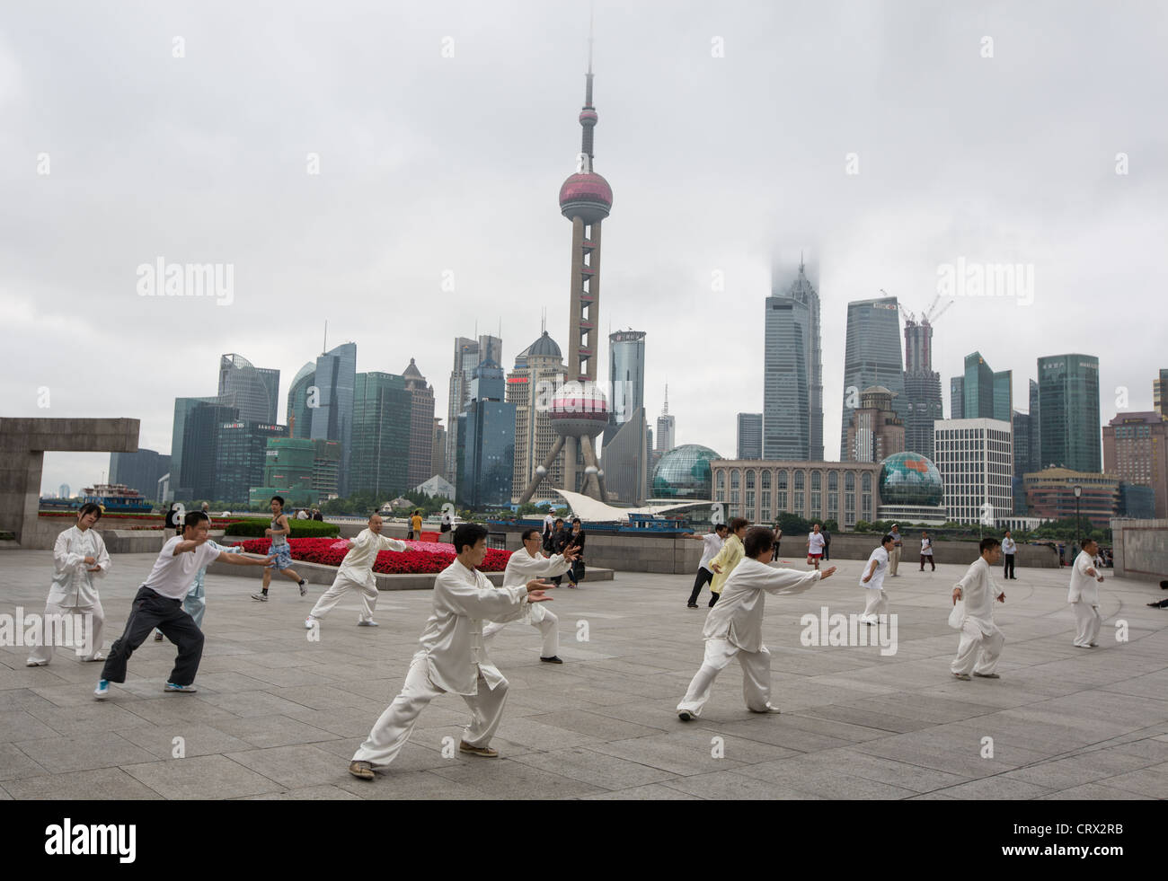 Early morning tai chi on The Bund in Shanghai, with Pudong skyline in ...