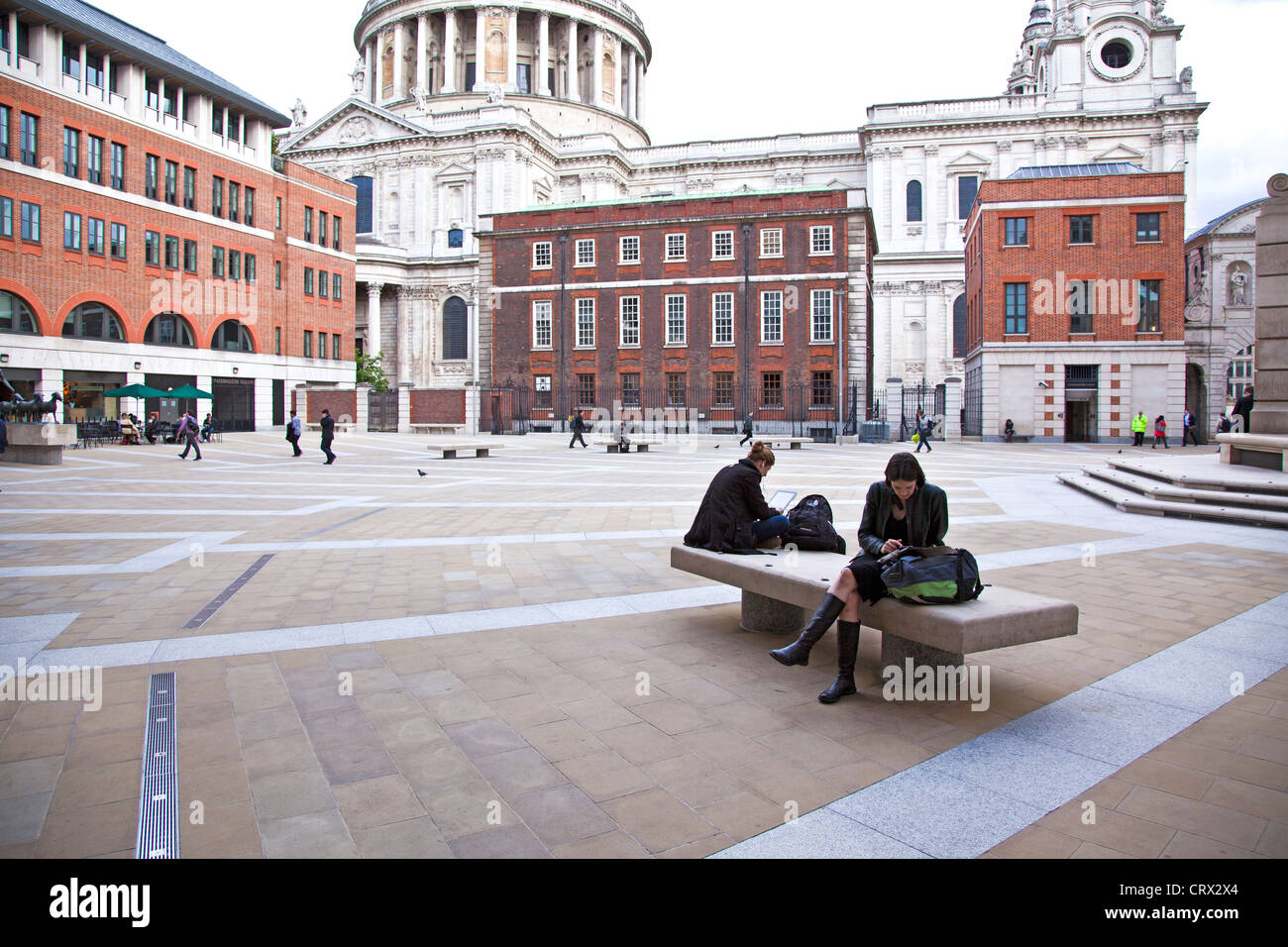 Two Women Checking Their Handheld Devices Stock Photo - Alamy