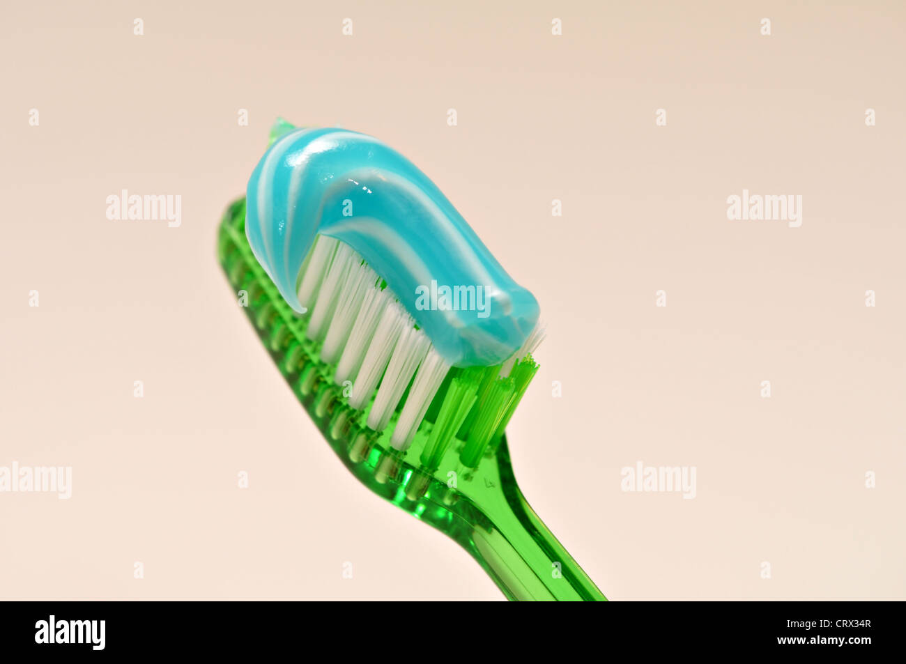 A green tooth brush with blue and white tooth paste on it Stock Photo ...