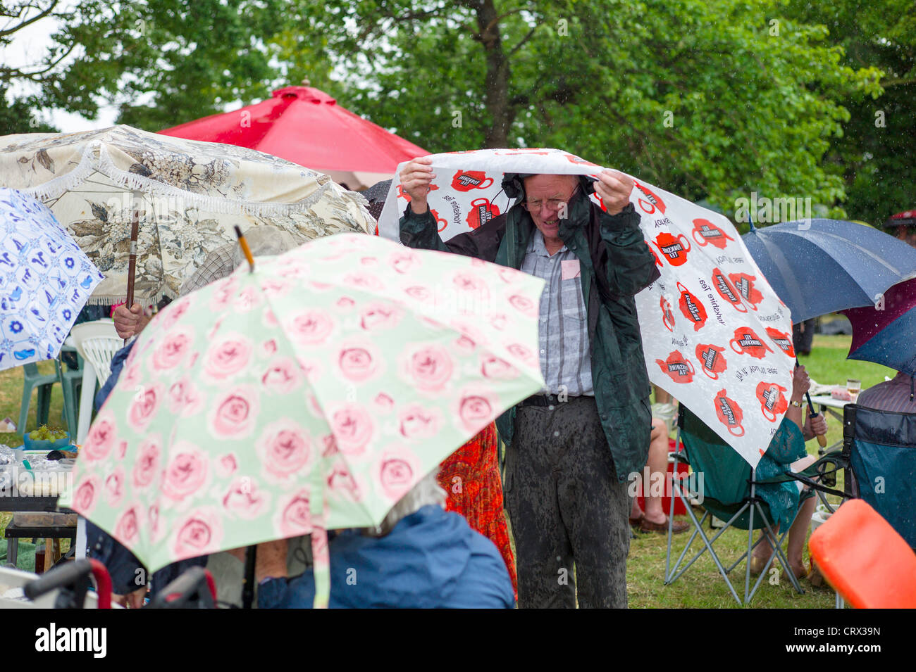Group of people taking cover from the elements at a jazz picnic Stock ...