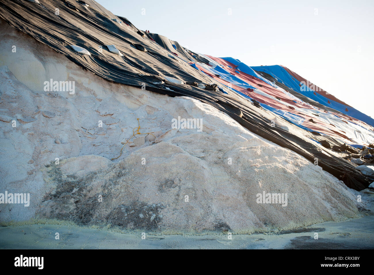 Piles of salt, used to prevent freezing on roads during winter storms ...
