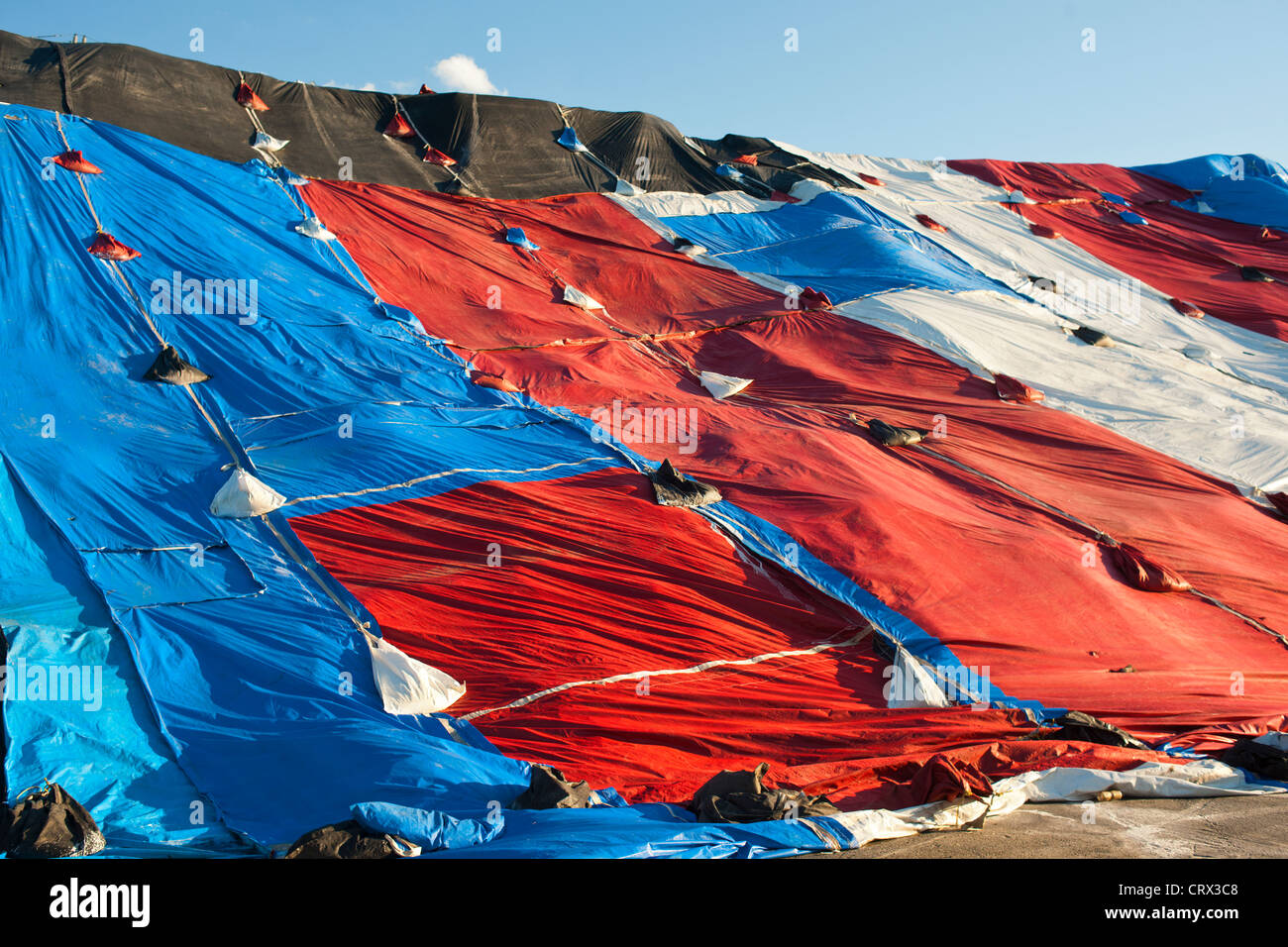 Piles of salt, used to prevent freezing on roads during winter storms ...