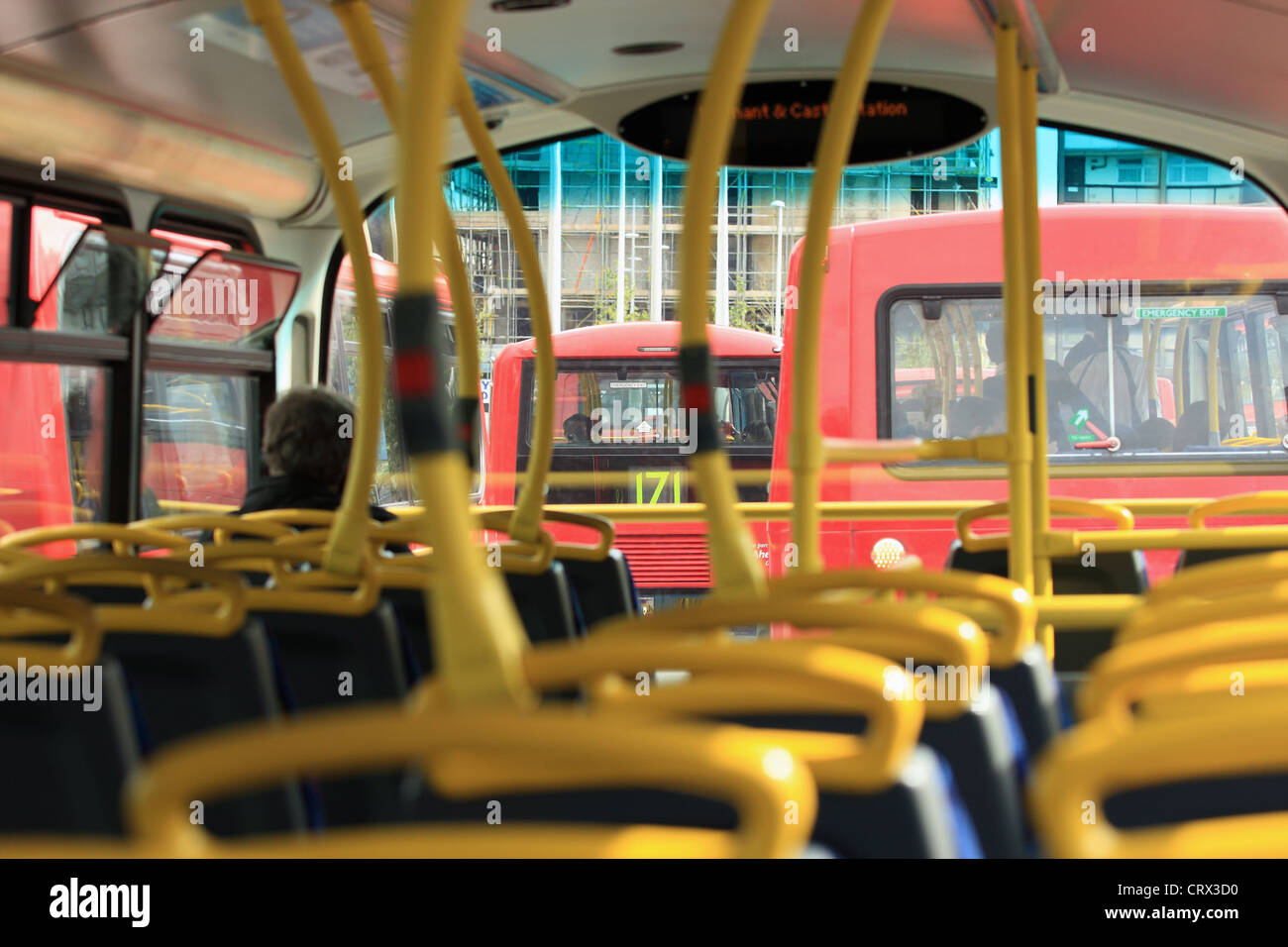 a view along the top deck of a London double decker bus including other ...