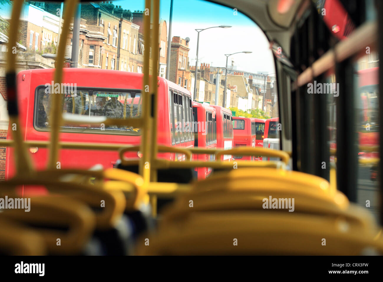 a view along the top deck of a London double decker bus including other ...