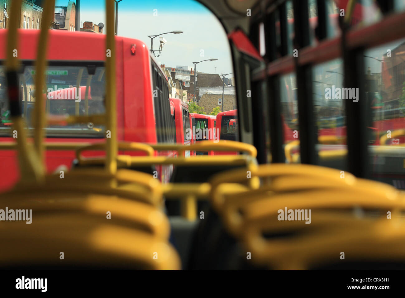 a view along the top deck of a London double decker bus including other ...