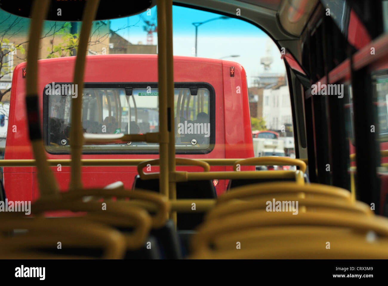 a view along the top deck of a London double decker bus including other ...