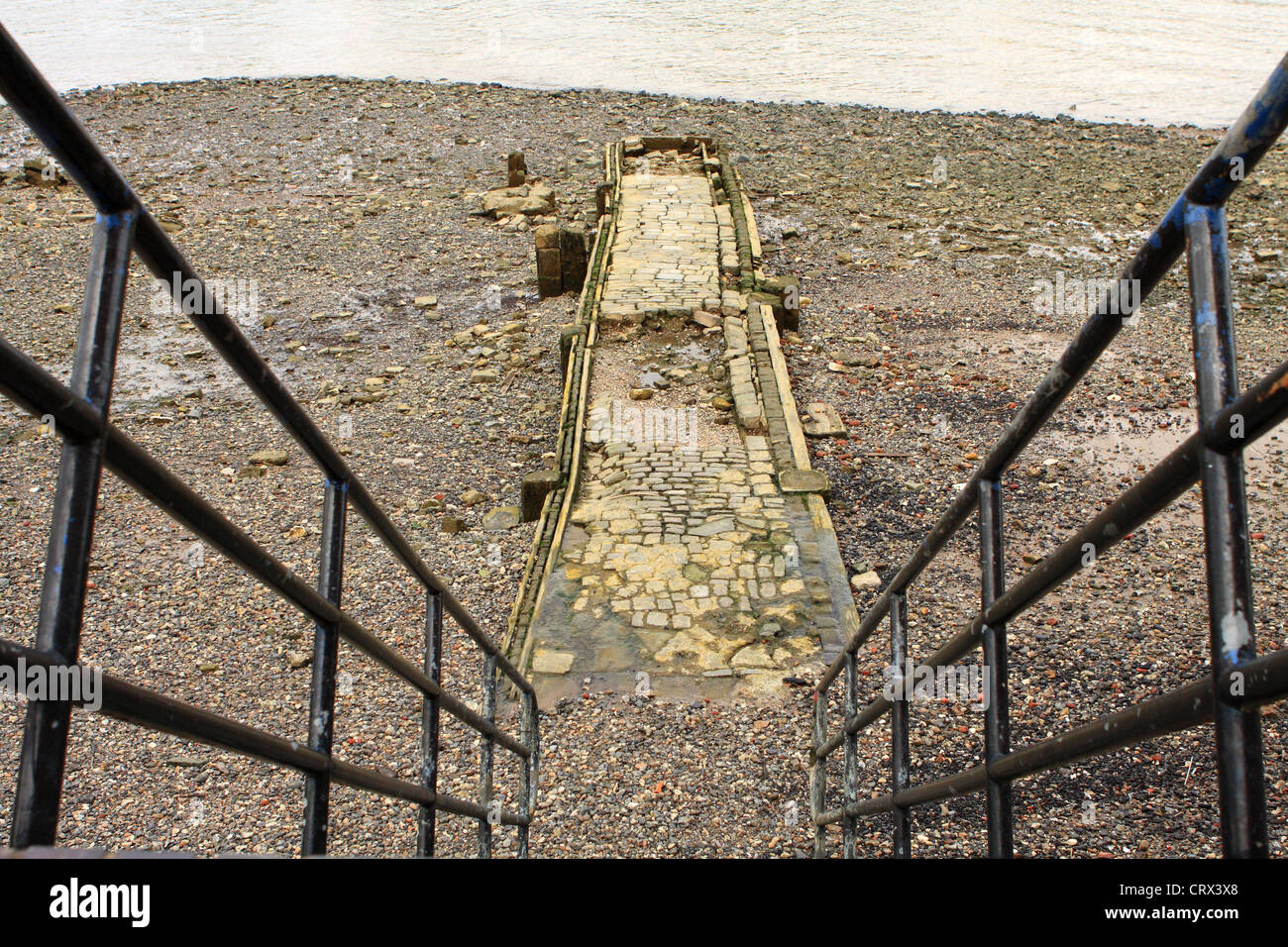 A view, at low tide, from the embankment of the River Thames down metal ...