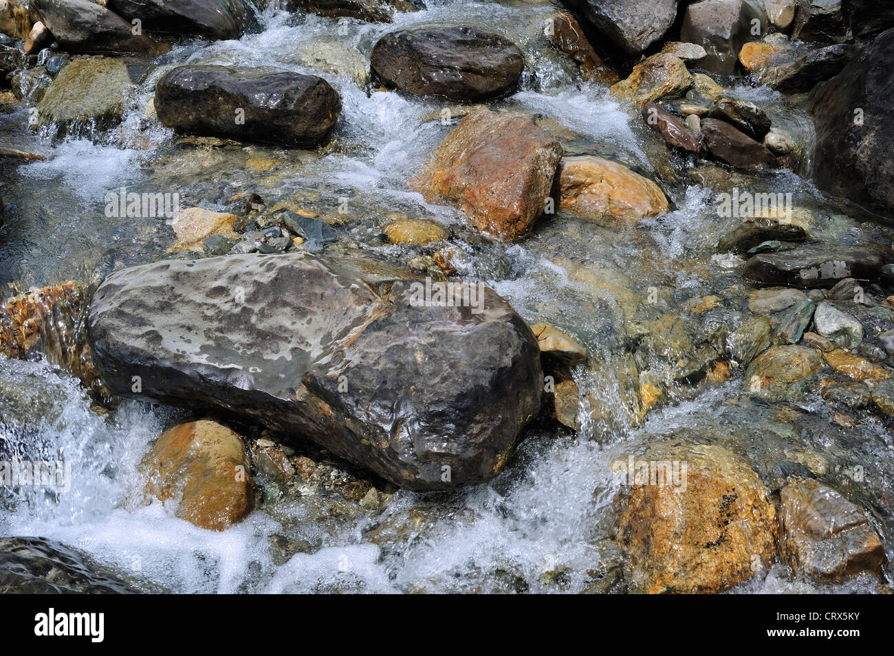 Boulders in fast flowing mountain stream, Pyrenees, France Stock Photo ...