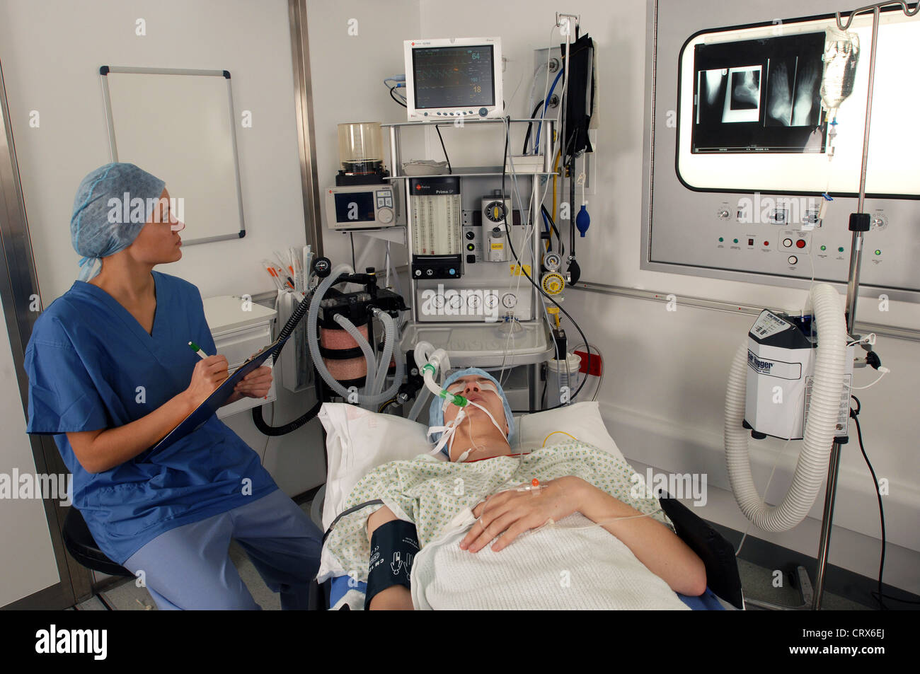 Nurse checking up on patient Stock Photo - Alamy