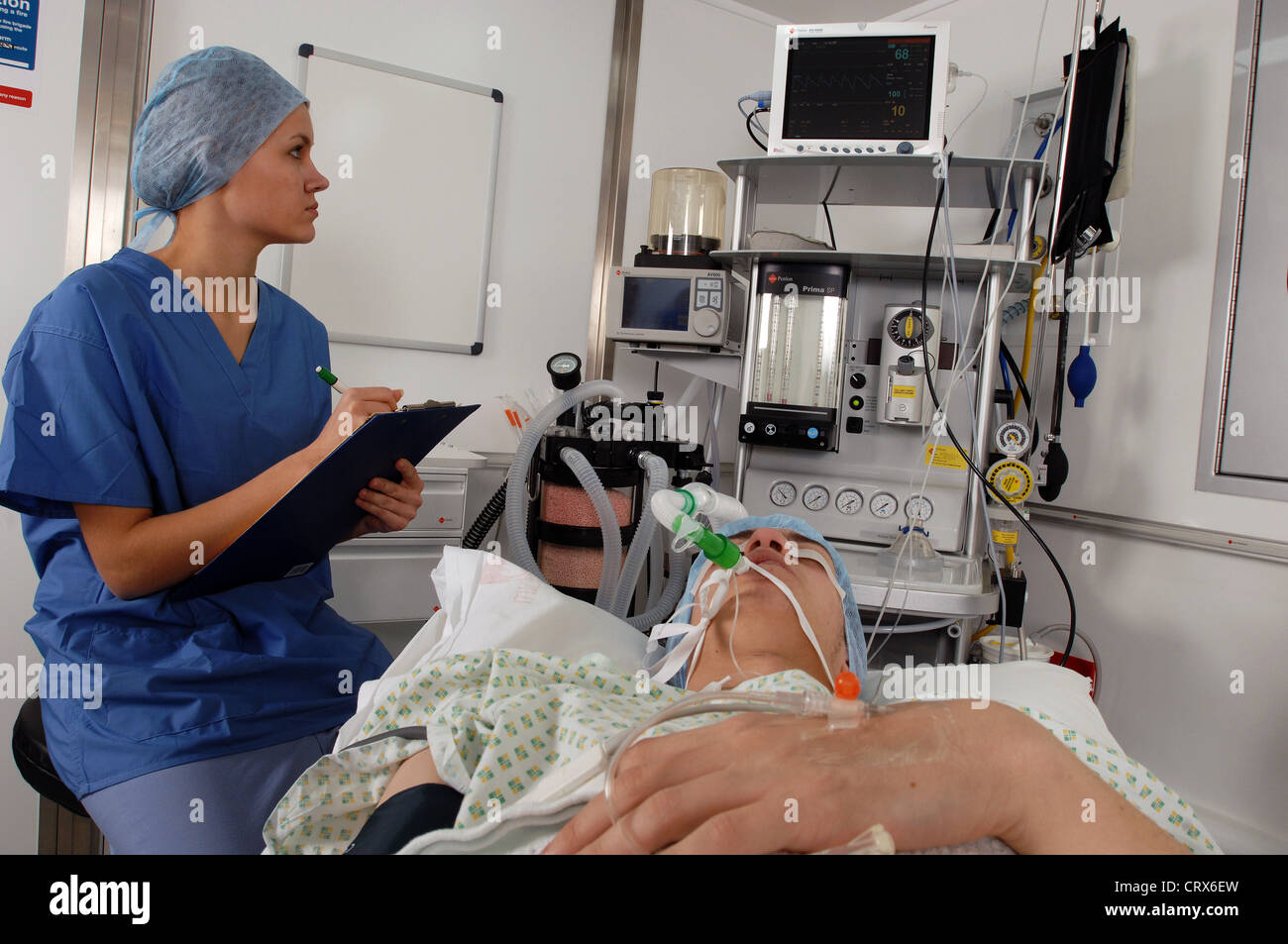 Nurse checking up on patient Stock Photo - Alamy