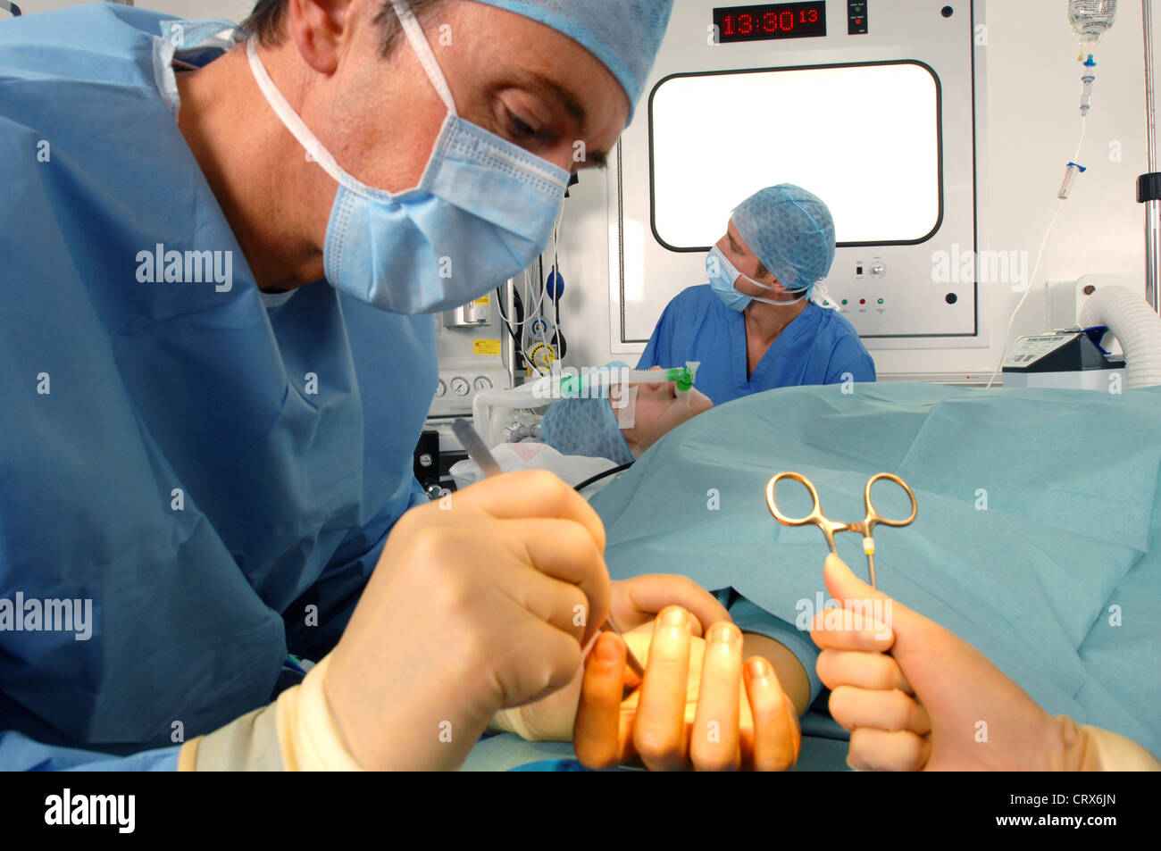 A surgeon and anesthetist operate on a patient's hand Stock Photo - Alamy