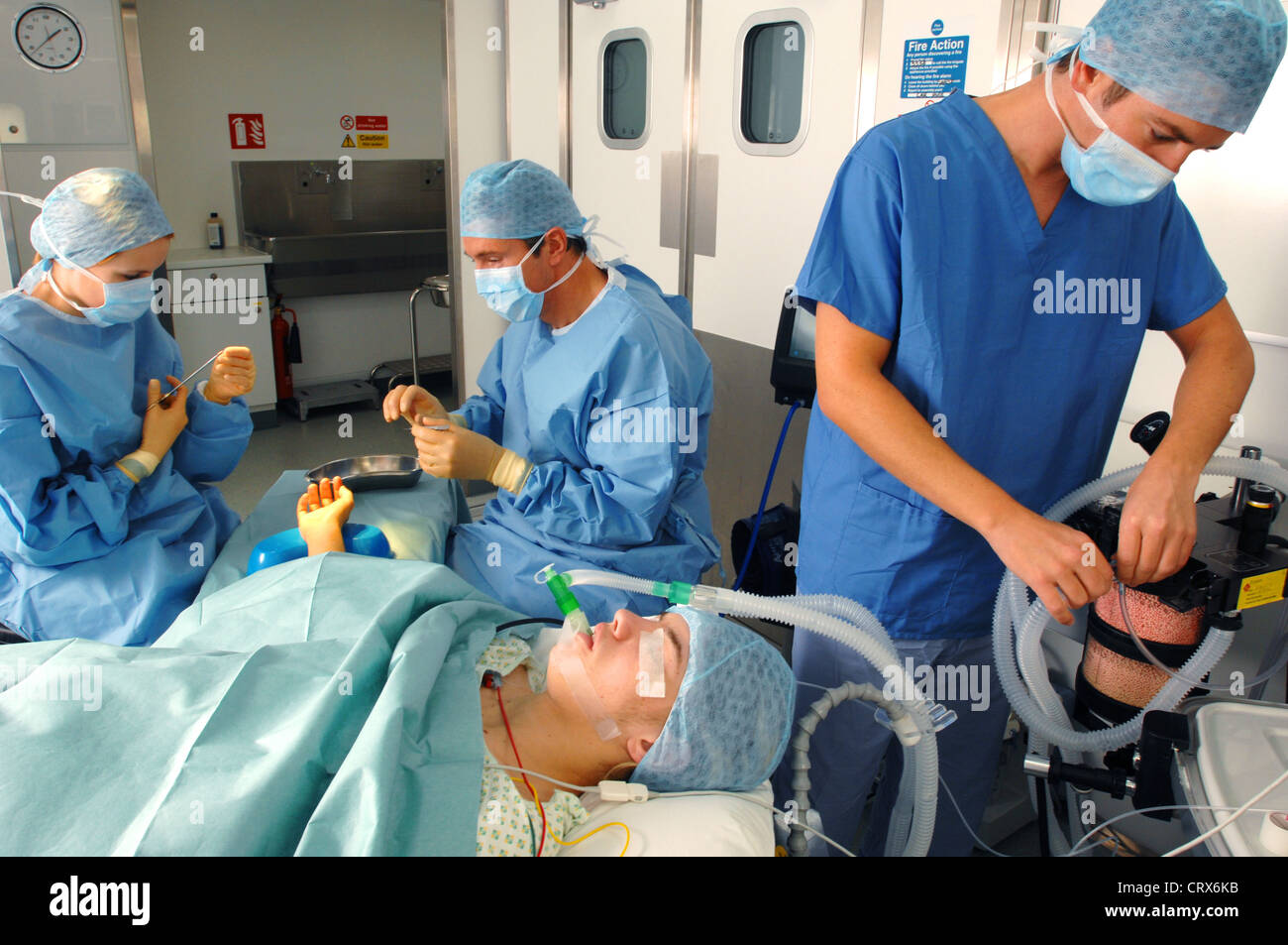 Surgeon, anesthetist and nurse perform an operation on the hand of a ...