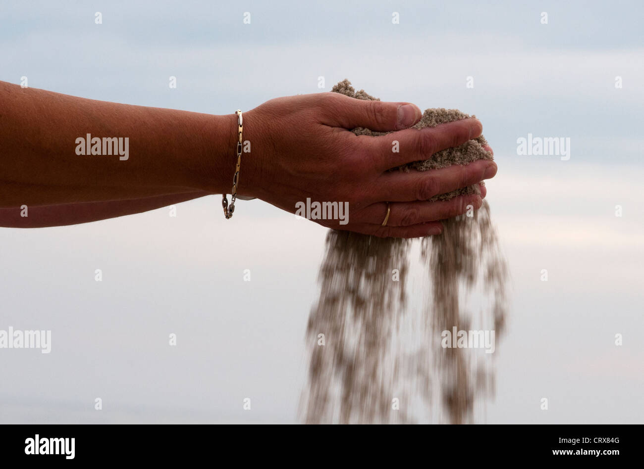 time passing by as sand trough the fingers from the hands Stock Photo ...