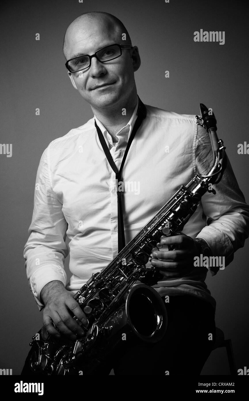 Black and white portrait of a man holding a saxophone Stock Photo - Alamy