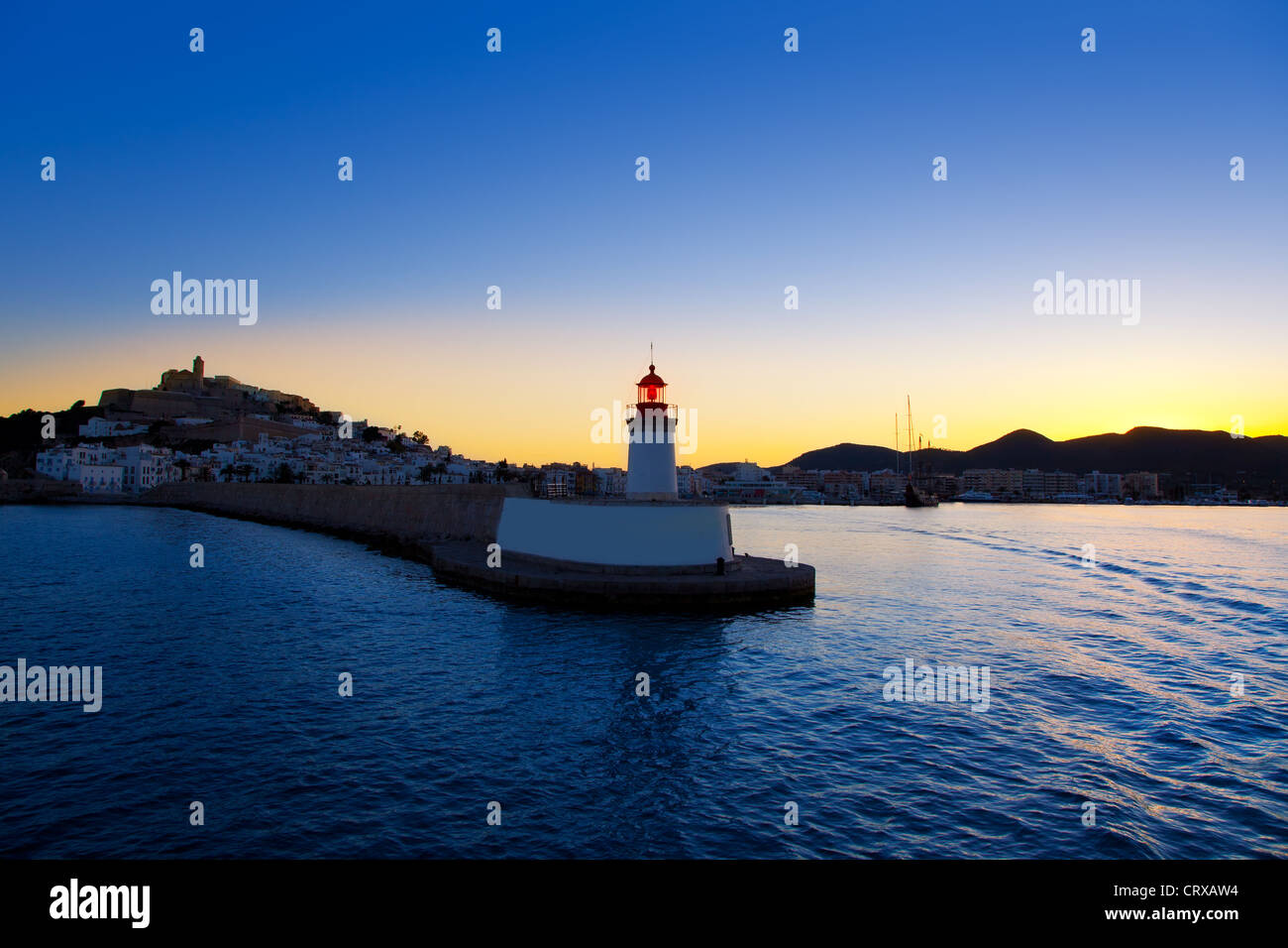 Eibissa Ibiza town sunset from red lighthouse beacon in port Stock ...