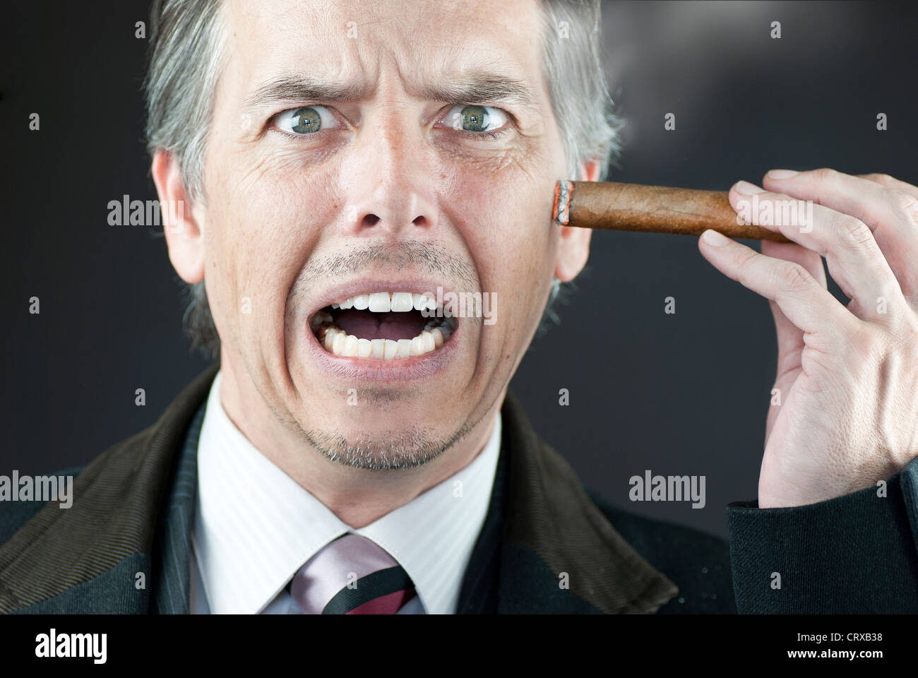 Businessman smoking cigar hi-res stock photography and images - Alamy