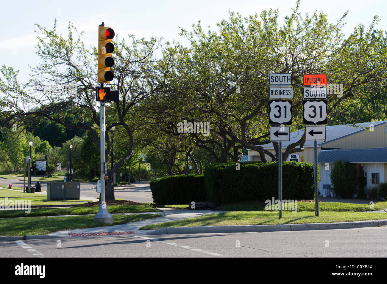 Traffic signal on a street post in a small town USA. Highway signs ...