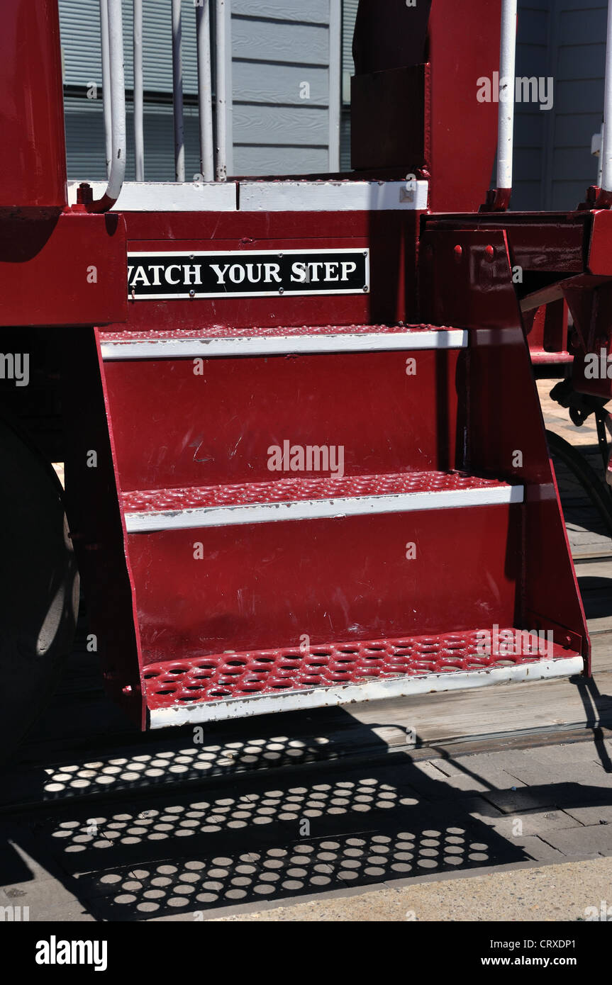 Watch your step sign on old train steps Stock Photo - Alamy