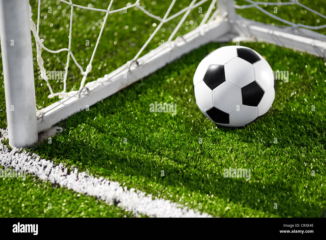 Soccer ball and goal net Stock Photo - Alamy