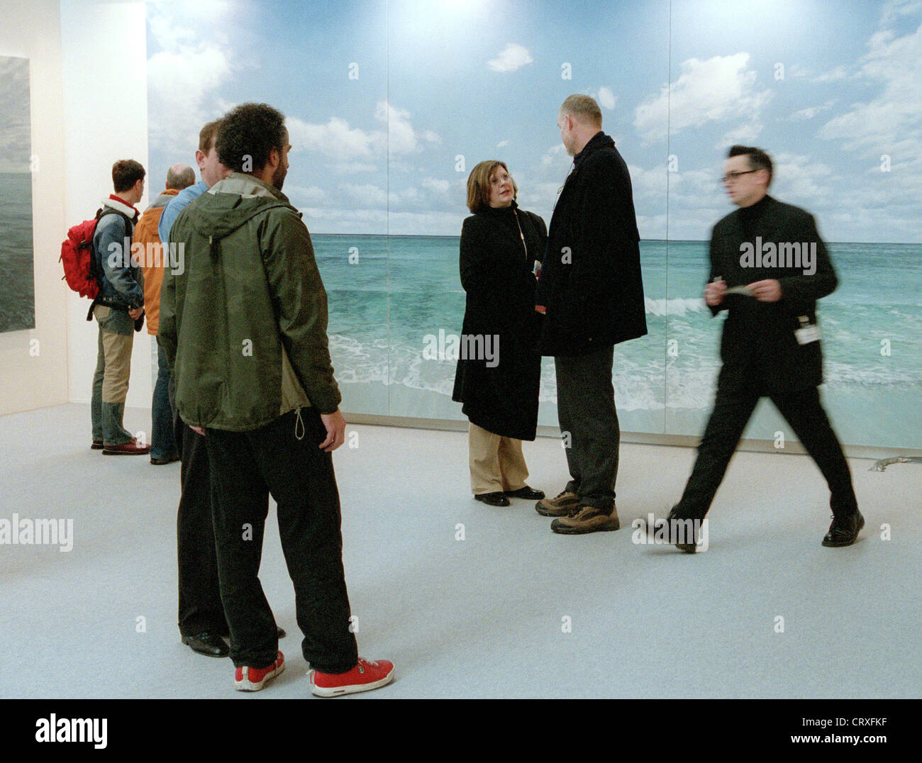 Visitors in front of a picture with a sea view Stock Photo - Alamy